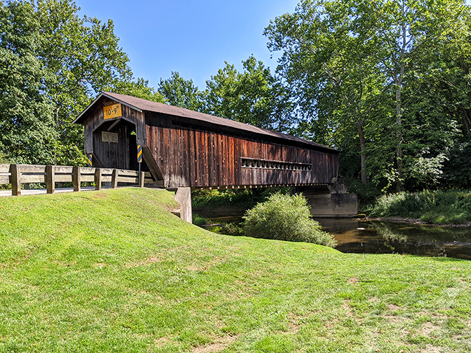 Like a wooden sentinel standing guard over the Ashtabula River, this historic bridge has weathered Ohio's seasons for generations with quiet dignity.