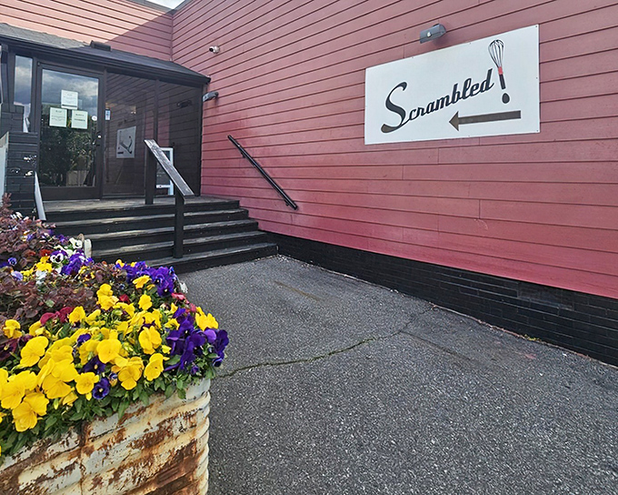 That whimsical sign with its playful whisk logo is the North Star for breakfast pilgrims seeking pancake perfection in Greensboro.