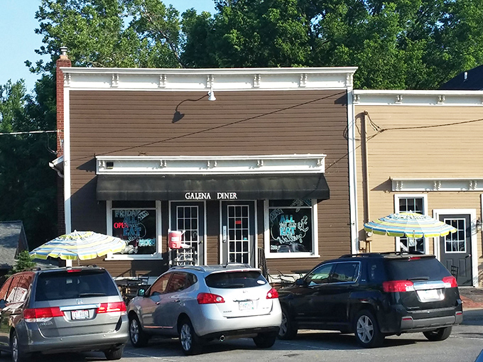 A different view of Galena Diner's exterior showcases its warm brown tones and inviting patio seating—small-town charm personified.