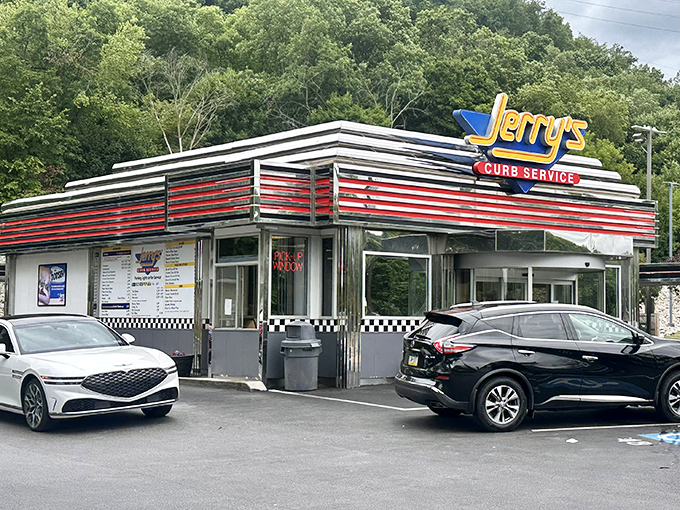 The gleaming red and silver stripes of Jerry's Curb Service stand as a time portal to America's golden age of drive-ins. No DeLorean required.
