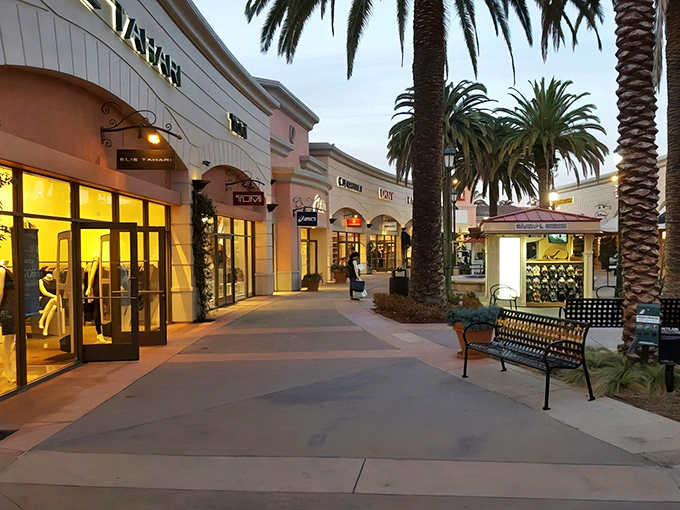 Palm trees stand sentinel along this Mediterranean-inspired shopping paradise, where the evening glow transforms bargain hunting into a glamorous affair.