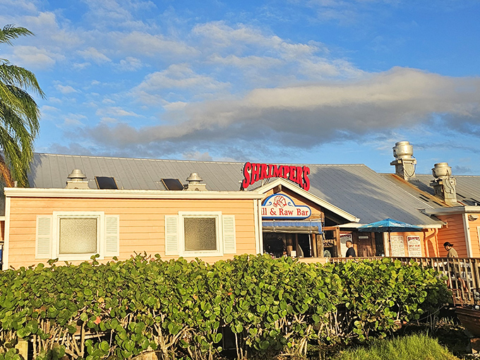 Shrimpers' peachy exterior glows in the Florida sunset like a postcard come to life. That red sign promises seafood salvation for hungry travelers.
