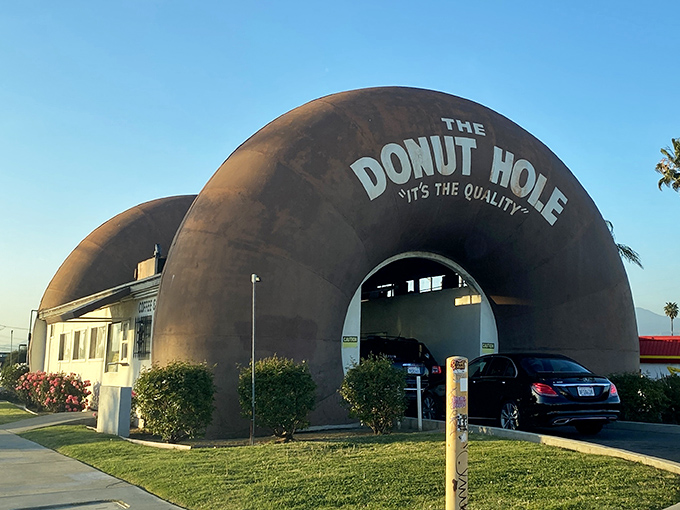 Cars queue through the giant donut portal, a sweet passage that transforms an ordinary drive-through into a memorable adventure.