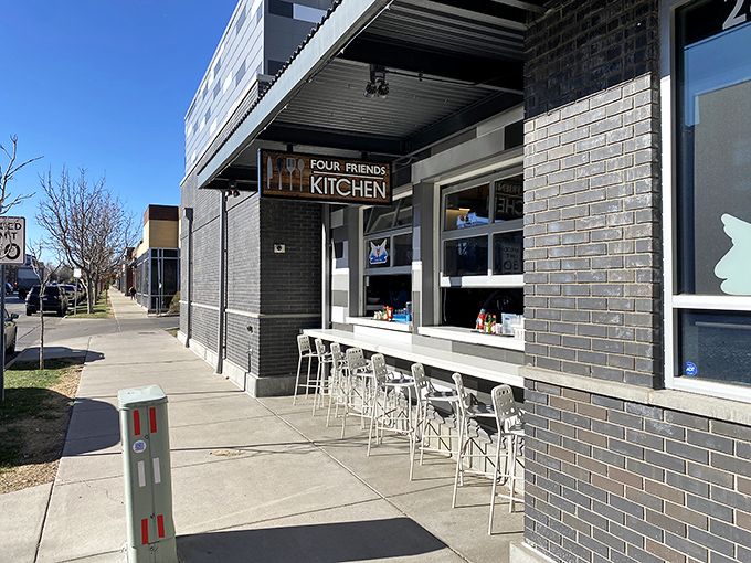 A welcoming sidewalk view showcases the restaurant's sleek design and outdoor seating area&mdash;perfect for people-watching while sipping that essential morning coffee.