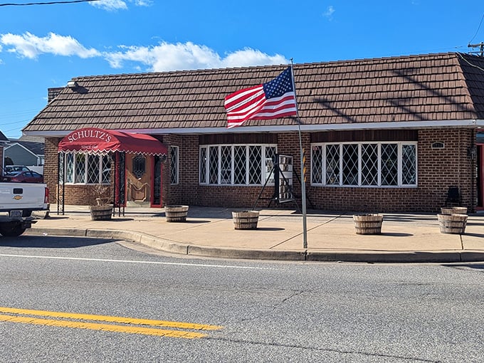 The unassuming brick exterior of Schultz's Crab House stands like a sentinel of seafood tradition, its red awning beckoning hungry travelers like a maritime flag.
