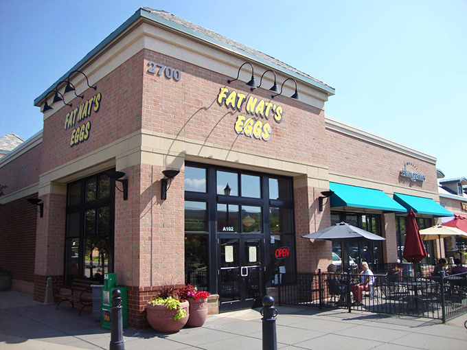 Sunshine bathes Fat Nat's cheerful exterior, where the bright yellow sign serves as Minnesota's most delicious morning invitation.