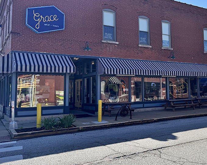 The classic blue and white striped awnings of Grace Meat + Three welcome hungry visitors like a culinary lighthouse in The Grove neighborhood.
