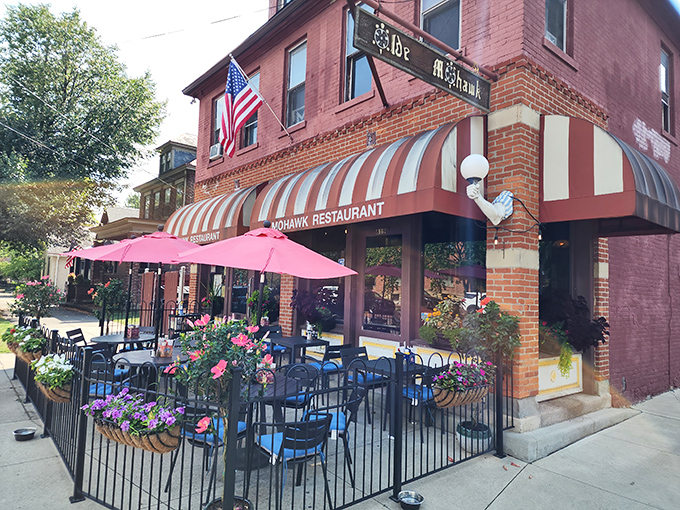 Summer dining perfection: The Old Mohawk's flower-adorned patio invites you to enjoy comfort classics under those cheerful pink umbrellas.
