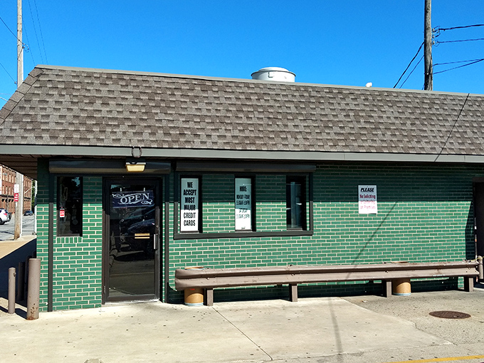 The unassuming green brick exterior of Superior Restaurant stands like a culinary fortress, promising treasures within that fancy facades could never deliver.