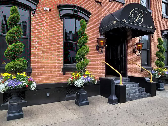 Victorian elegance meets culinary adventure at The Belvedere's entrance, where spiral topiaries stand like ma&icirc;tre d's welcoming you to Lancaster's dining gem.
