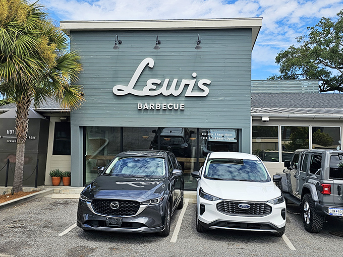 The iconic seafoam-green exterior of Lewis Barbecue stands like a beacon of hope for hungry travelers. Palm trees add that perfect Charleston touch.