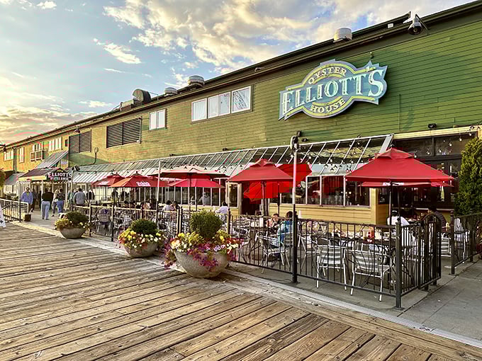 Elliott's iconic green exterior with vibrant red umbrellas beckons seafood lovers like a maritime siren song on Seattle's historic waterfront.