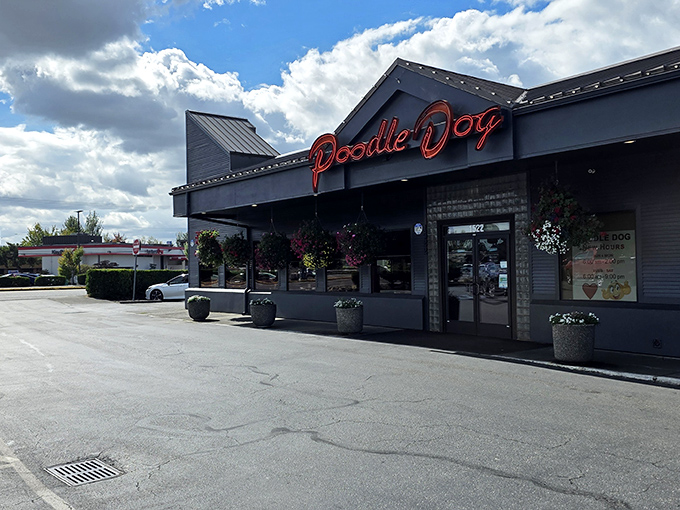 The iconic red neon "Poodle Dog" sign beckons hungry travelers like a lighthouse for the famished. This roadside landmark promises comfort food salvation just off I-5.