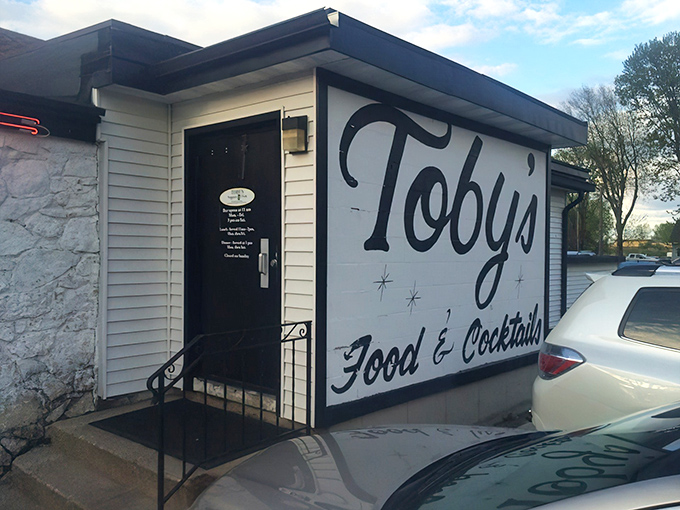 The unassuming entrance to Toby's Supper Club proves the old adage: never judge a culinary treasure by its modest exterior.