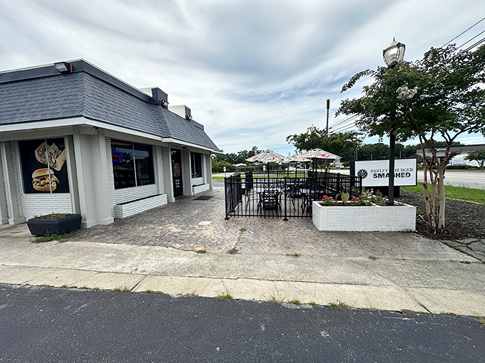 A cozy patio welcomes burger enthusiasts. The outdoor seating area offers a perfect perch for people-watching while demolishing a perfectly smashed patty.