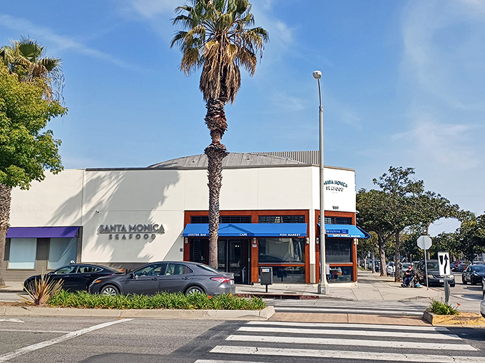 The unassuming exterior of Santa Monica Seafood stands like a culinary lighthouse, beckoning seafood lovers with its simple white walls and iconic blue awnings.