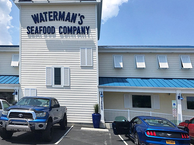 The white clapboard exterior of Waterman's stands proud against the blue sky, like a maritime flag signaling "Seafood Ahead!" to hungry Ocean City visitors.