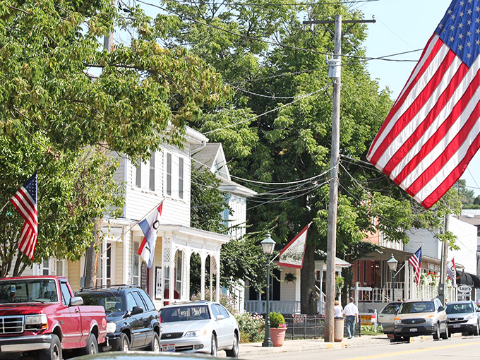 American flags wave proudly along Main Street, where patriotism comes standard with your morning coffee and friendly waves.