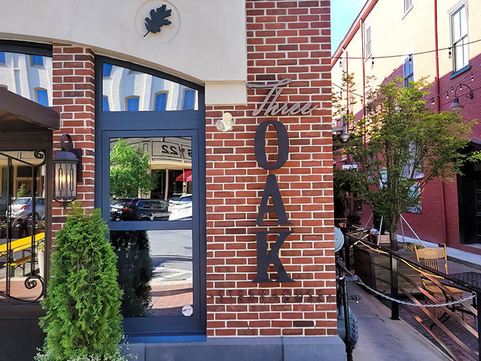 The brick facade of Three Oak Steakhouse welcomes you with elegant metal lettering and lush greenery&mdash;like a sophisticated friend inviting you in for dinner.