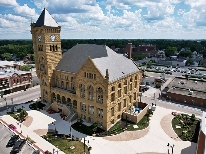 The Wells County Courthouse stands like a limestone sentinel, its clock tower keeping watch over Bluffton's affordable charm since the 19th century.