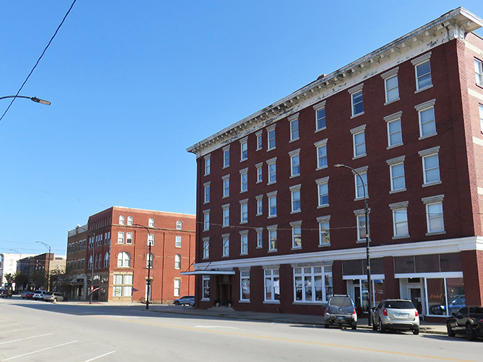 Historic brick buildings stand tall against a clear Kansas sky, offering affordable housing options that won't make your retirement fund weep.