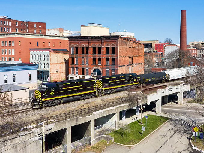 Trains still rumble through the heart of Jamestown, a living postcard of America's industrial heritage against brilliant blue skies.