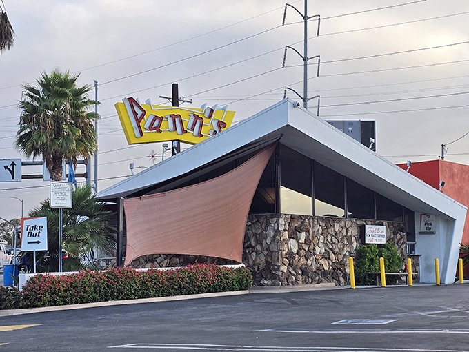 That dramatic roofline isn't just for show&mdash;it's architectural jazz, a visual symphony from an era when America's optimism reached for the stars.