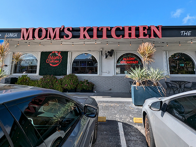 The iconic red signage of Mom's Kitchen beckons like a lighthouse for hungry souls, promising all-day breakfast and that unmistakable diner charm that chain restaurants can only dream of replicating.