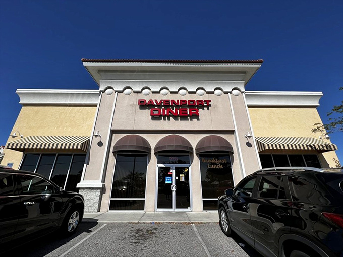 The bold red lettering against crisp white walls isn't just signage&mdash;it's a breakfast beacon calling to hungry souls across Davenport like a carb-loaded lighthouse.