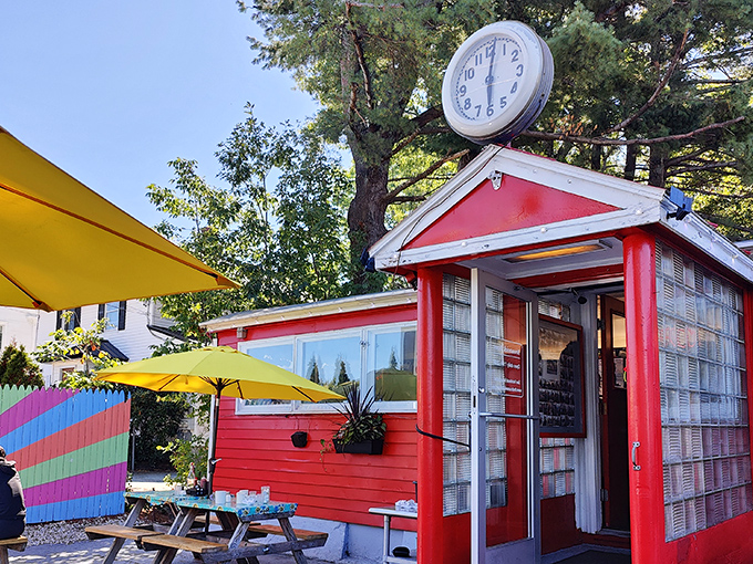 The Brunswick Diner's cherry-red exterior stands like a time capsule with its iconic clock, promising breakfast bliss that's worth setting your watch for.