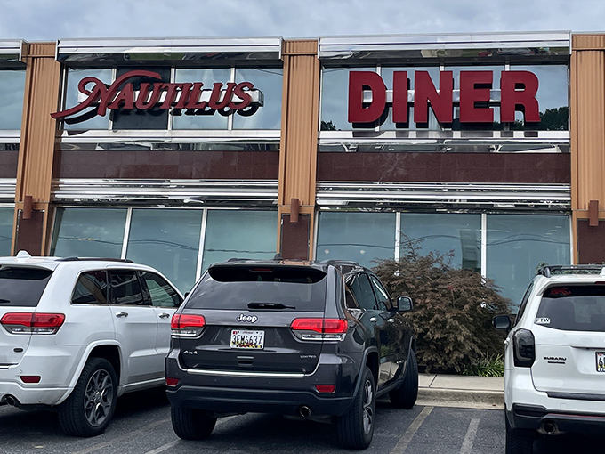 The gleaming chrome and bold red signage of Nautilus Diner stands like a beacon for hungry travelers, promising classic comfort in Crofton's bustling landscape.