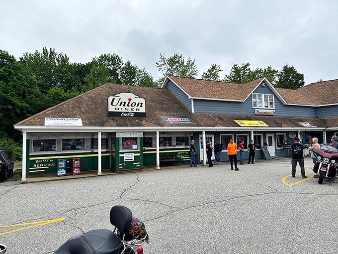 The blue exterior of Union Diner stands as a beacon of breakfast hope in Laconia, where motorcycles and family sedans share parking spaces in delicious democracy.
