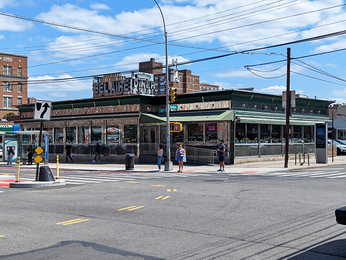 The gleaming chrome exterior of Bel Aire Diner stands as an Astoria landmark, its vintage sign beckoning hungry New Yorkers like a neon North Star for comfort food pilgrims.