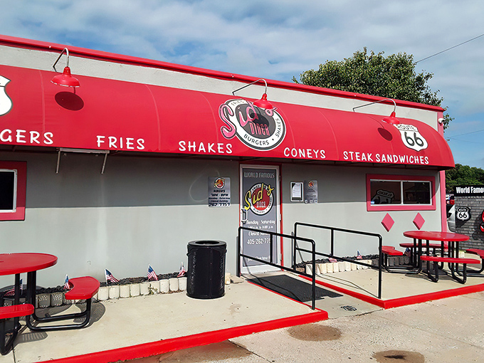 The bright red awning of Sid's Diner stands out like a beacon on Route 66, promising comfort food nirvana to weary travelers and hungry locals alike.