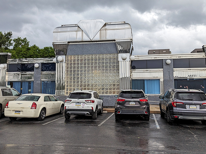 The gleaming, retro-futuristic exterior of Springfield Diner stands like a chrome-clad time machine waiting to transport hungry travelers back to the golden age of American dining.