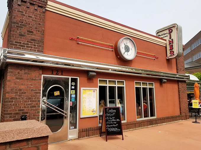 The orange facade and vintage clock aren't just Instagram bait&mdash;they're a promise that inside awaits the kind of breakfast that makes Monday mornings bearable.
