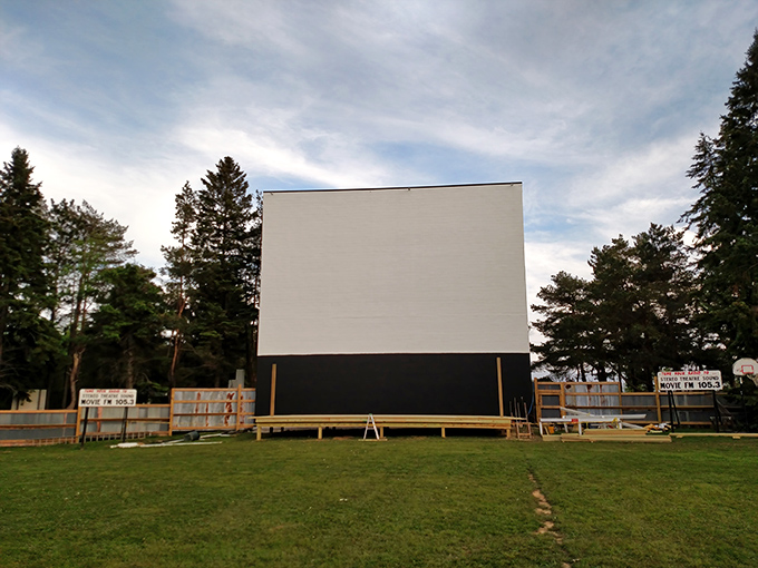 The massive white screen stands sentinel against Pennsylvania pines, waiting for dusk to transform it into a portal to other worlds.