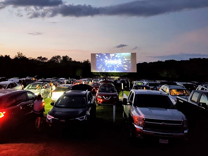 Twilight magic unfolds as cars gather beneath the glowing screen. Nothing beats watching the latest blockbuster with fireflies providing nature's special effects.