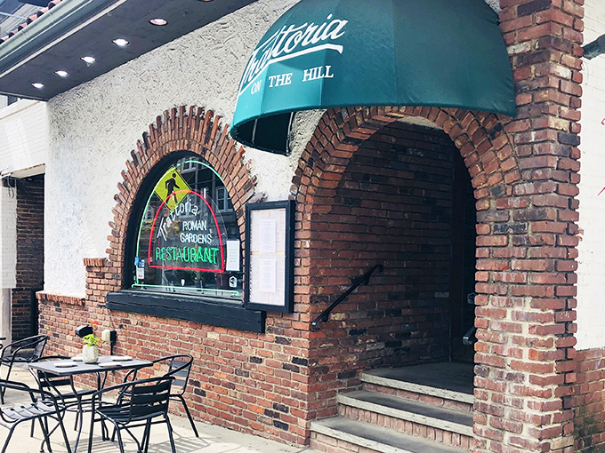 The iconic green awning and brick archway of Trattoria Roman Garden welcome you like an old friend inviting you in for dinner.