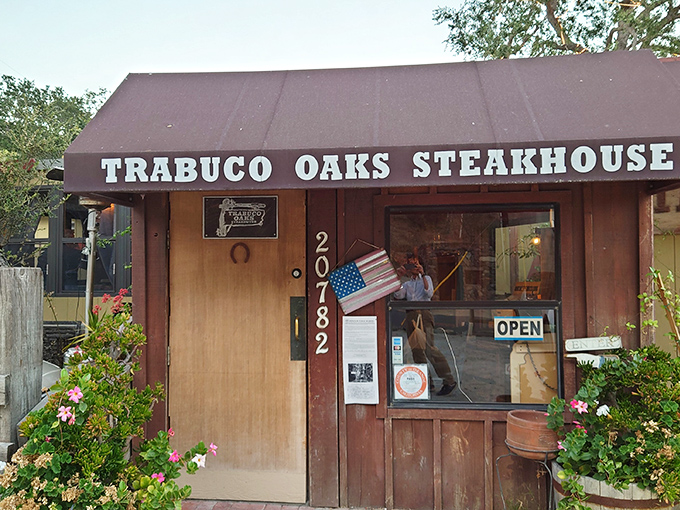 The unassuming entrance to culinary paradise &ndash; Trabuco Oaks Steakhouse stands proudly in its rustic glory, promising carnivorous delights behind that wooden door.