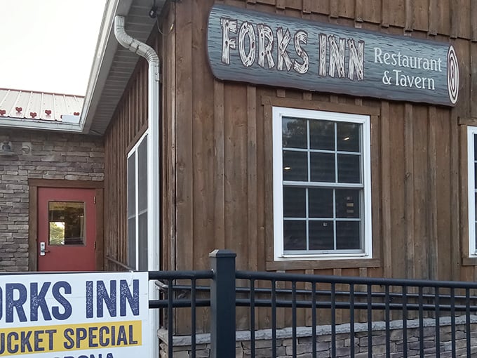 The rustic wooden exterior of Fork's Inn welcomes hungry travelers with its charming blue sign and promise of Pennsylvania tavern comfort. 