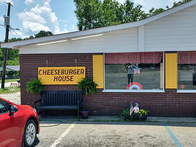 The unassuming brick exterior with bright yellow shutters stands as a testament that culinary greatness often hides in plain sight.