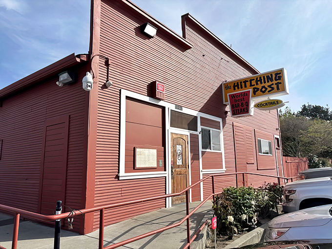 The iconic red exterior of the Hitching Post stands like a culinary lighthouse in Casmalia, beckoning hungry travelers with promises of oak-fired perfection.