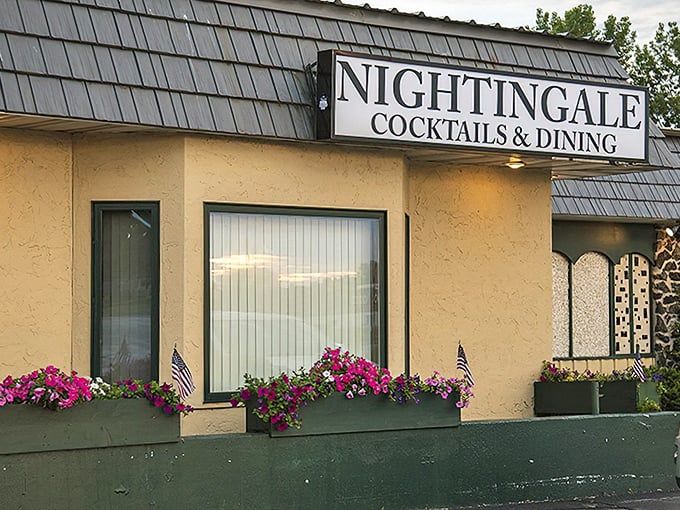 The unassuming exterior of Nightingale Supper Club, where vibrant flower boxes hint at the colorful culinary experience waiting inside.