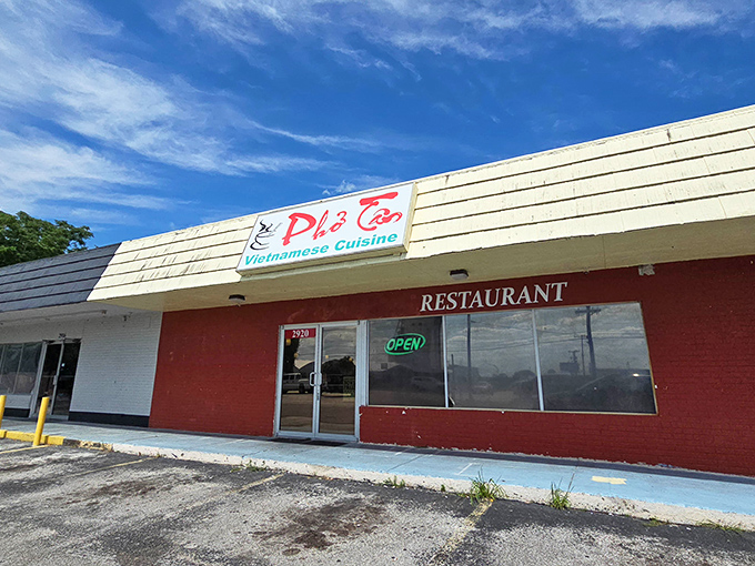 Bright Florida sunshine illuminates this humble storefront. The "OPEN" sign beckons like a green light to flavor country.