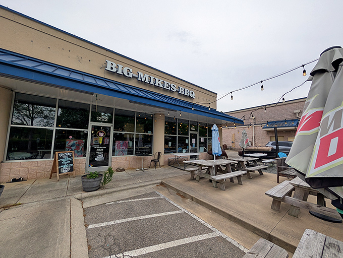 The yellow storefront of Big Mike's BBQ beckons like a barbecue lighthouse, promising smoky treasures within. Those picnic tables aren't just seating&mdash;they're front-row tickets to flavor town.