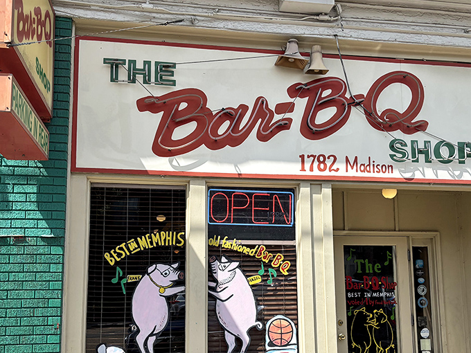 The mint-green storefront with its iconic dancing pigs logo promises barbecue nirvana before you even step inside.