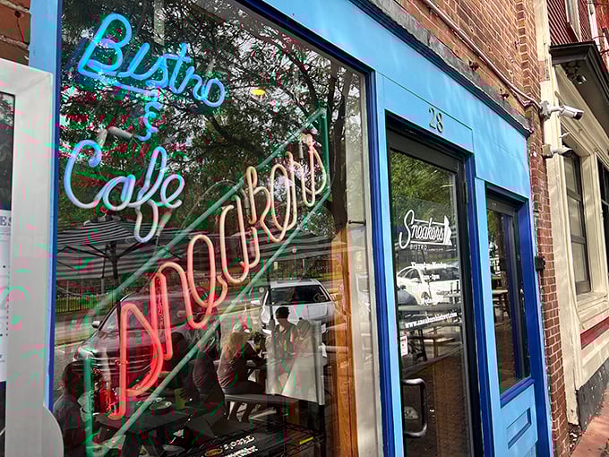 The neon-lit storefront of Sneakers Bistro glows like a beacon of breakfast hope on Winooski's main drag. Blue exterior, colorful signage&mdash;breakfast paradise awaits.
