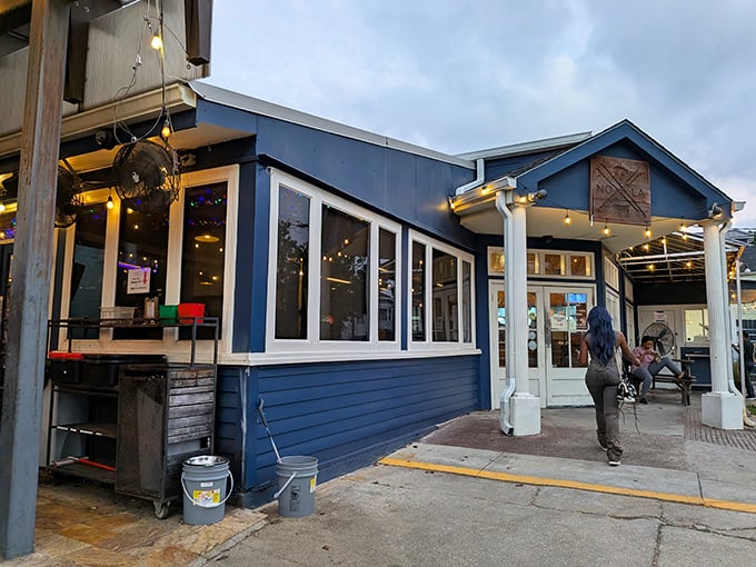 The blue exterior of Blue Oak BBQ stands out like a barbecue beacon in Mid-City New Orleans, promising smoky delights within those white-trimmed doors.