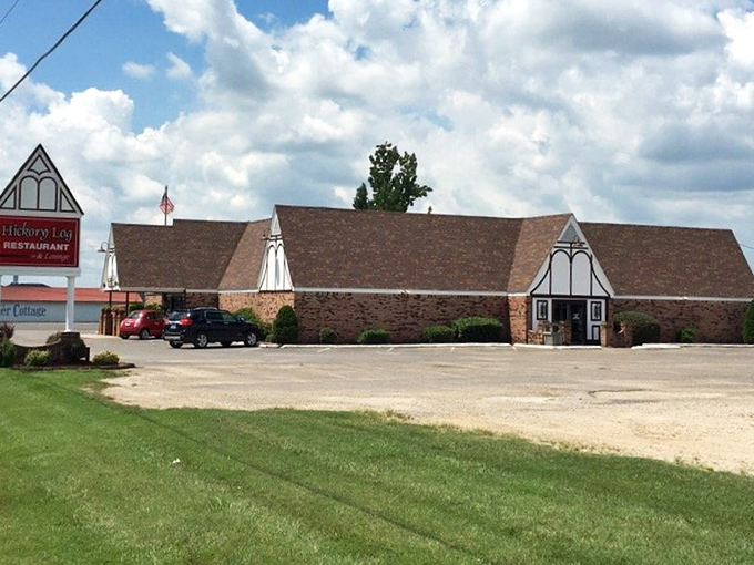 The distinctive A-frame architecture of Hickory Log Restaurant stands like a barbecue cathedral against the Missouri sky, beckoning hungry travelers with promises of smoky delights.